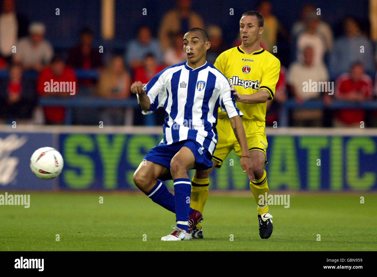 Colchester United's Craig Fagan (l) gets the ball away under pressure ...