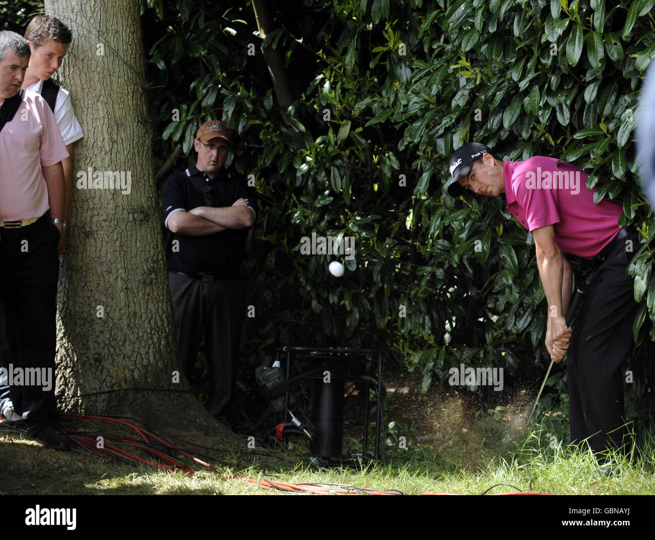 England's Ross Fisher plays from the bushes on the 1st hole during ...