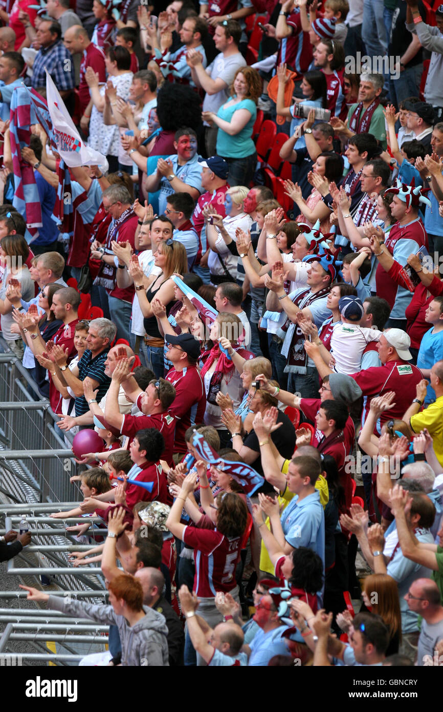 Scunthorpe United fans celebrate promotion in the stands Stock Photo ...