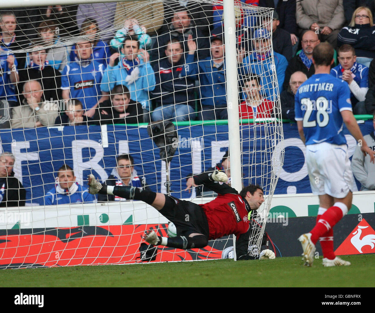 Rangers goalkeeper Neil Alexander is powerless to stop a shot flying in ...