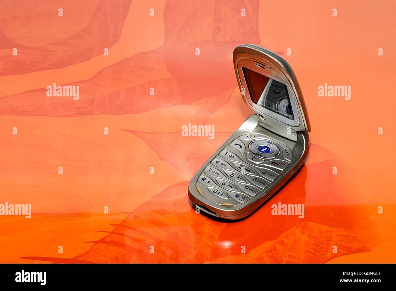 A classic hand phone isolated on a orange background Stock Photo - Alamy