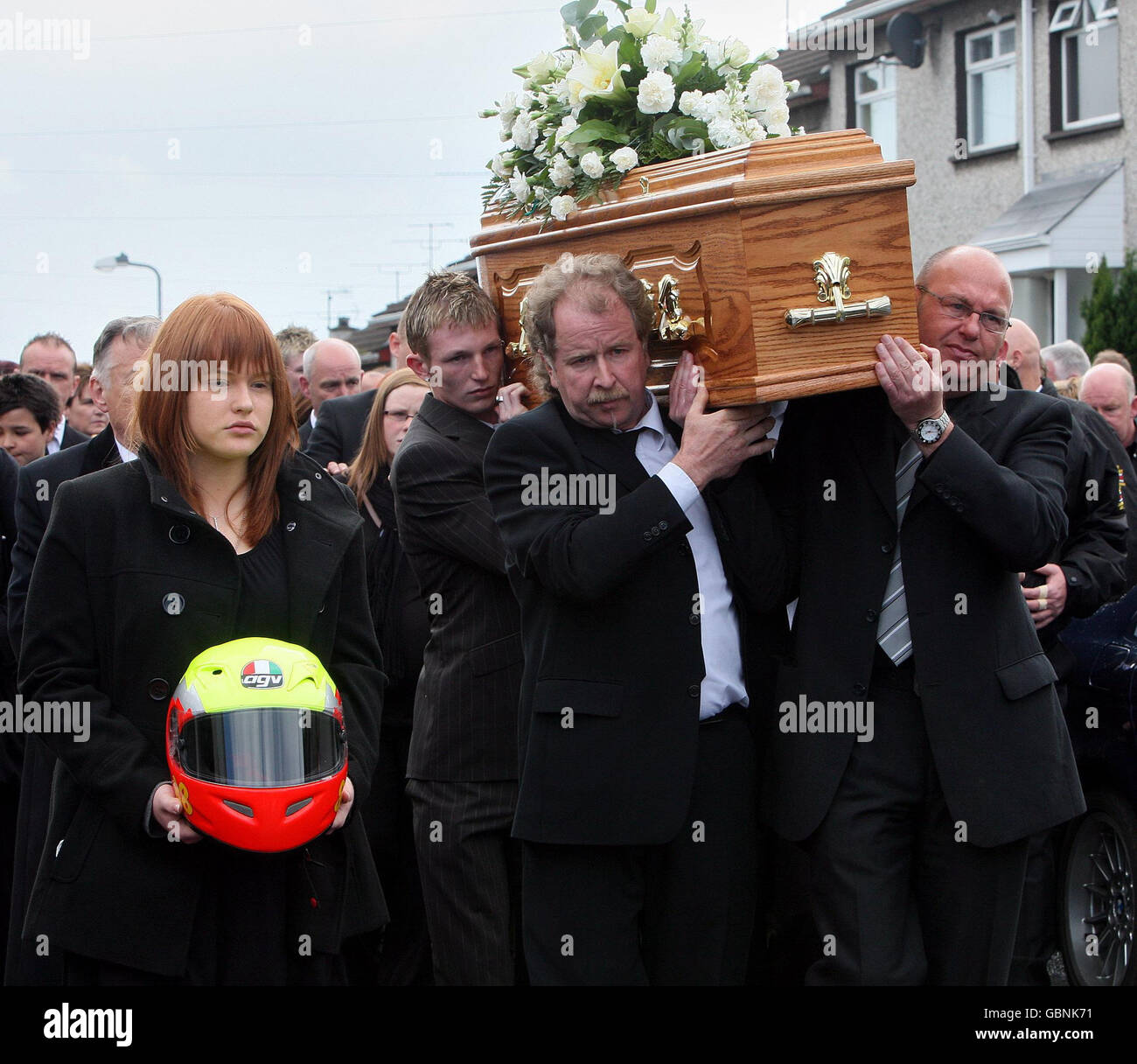Mark Young's girlfriend Tara, carries his racing helmet as the cortege ...