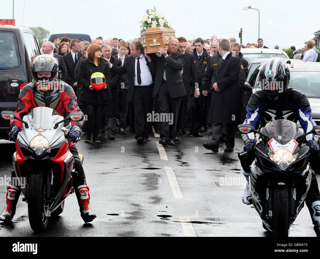 Mark Young's girlfriend Tara, carries his racing helmet as the cortege ...