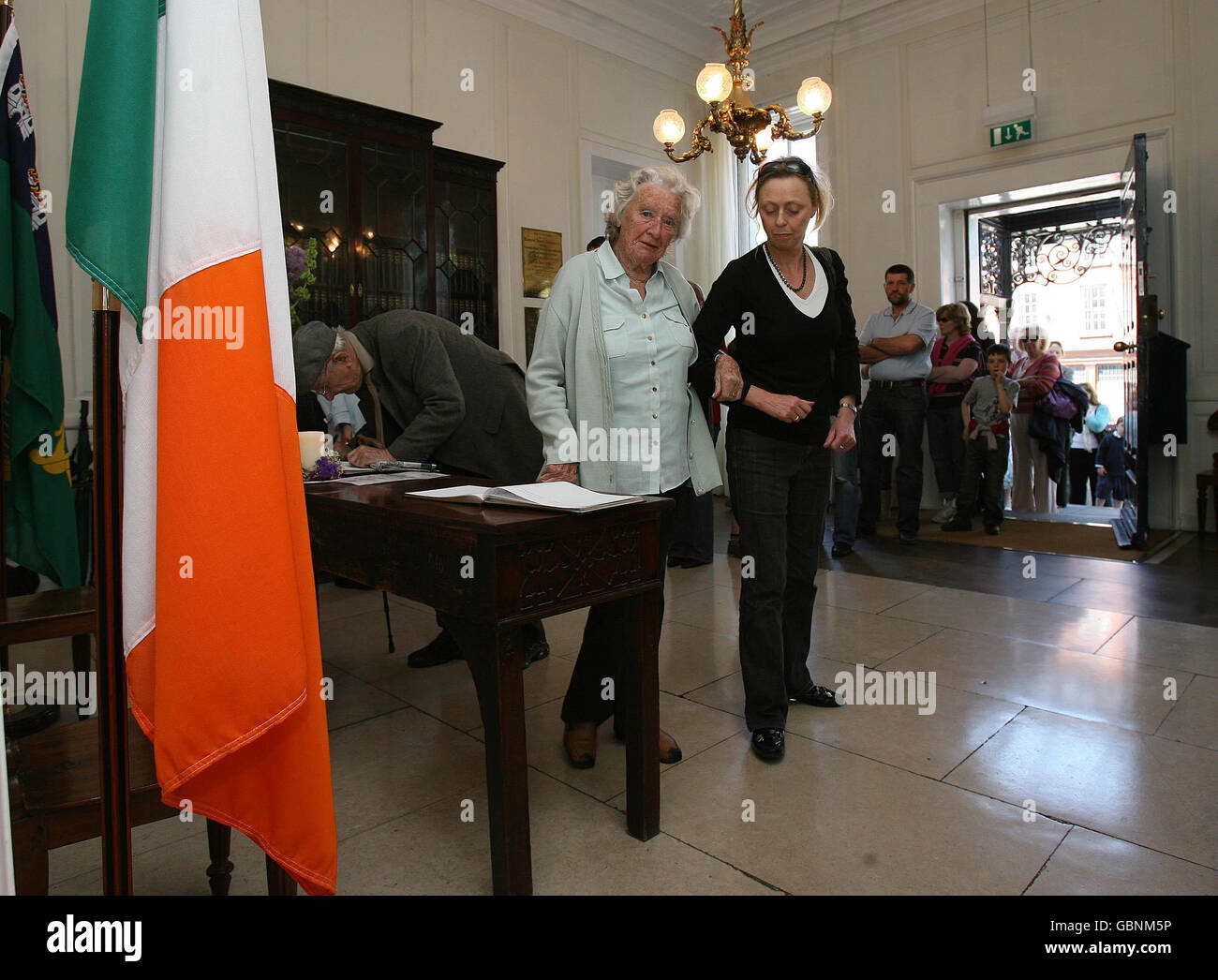 Members of the public sign a book of solidarity for the victims of ...