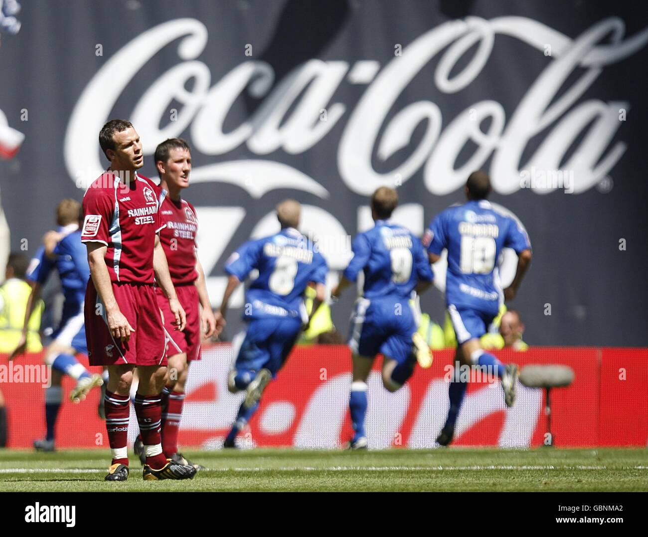 Scunthorpe United's Cliff Byrne (right) and Sam Togwell (left) stand ...