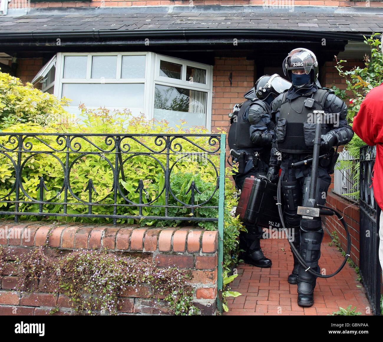 Police officers after raiding a house on the Lisburn Road in south ...