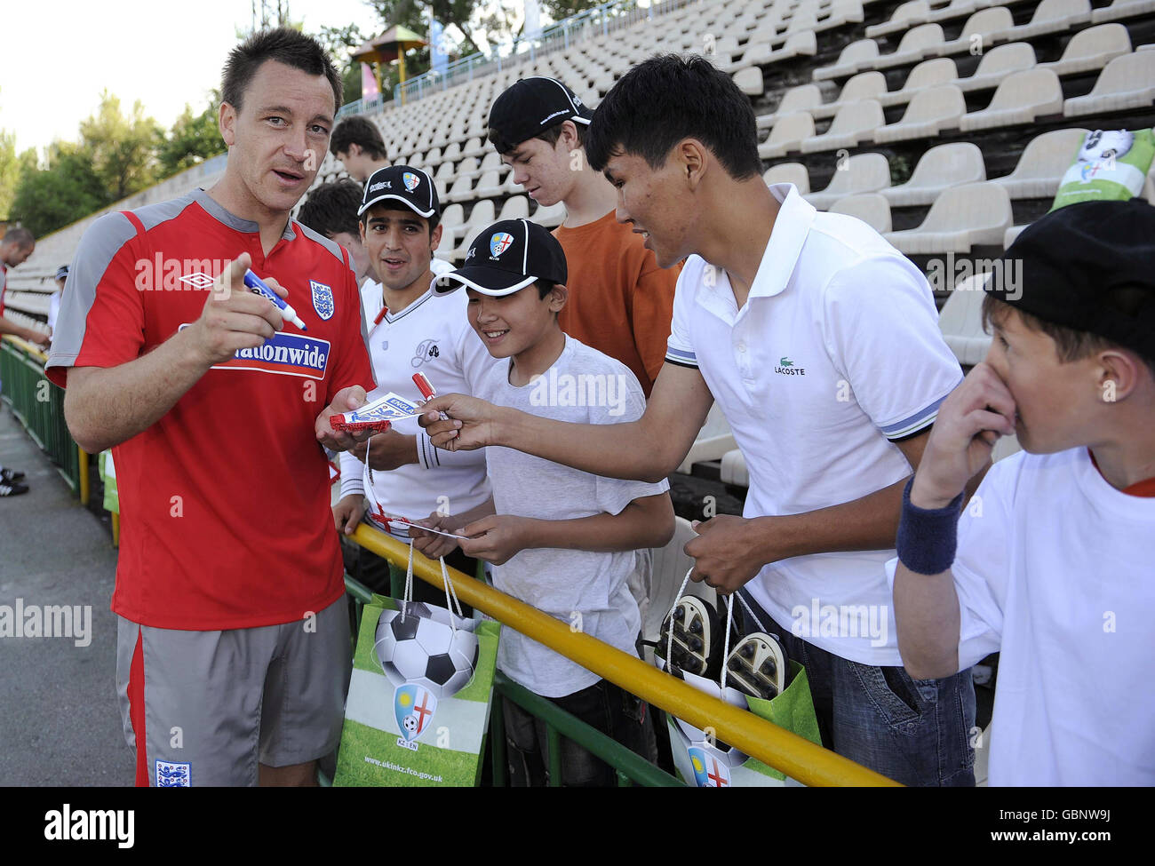 England's John Terry signs merchandise for fans at The Intercontinental ...