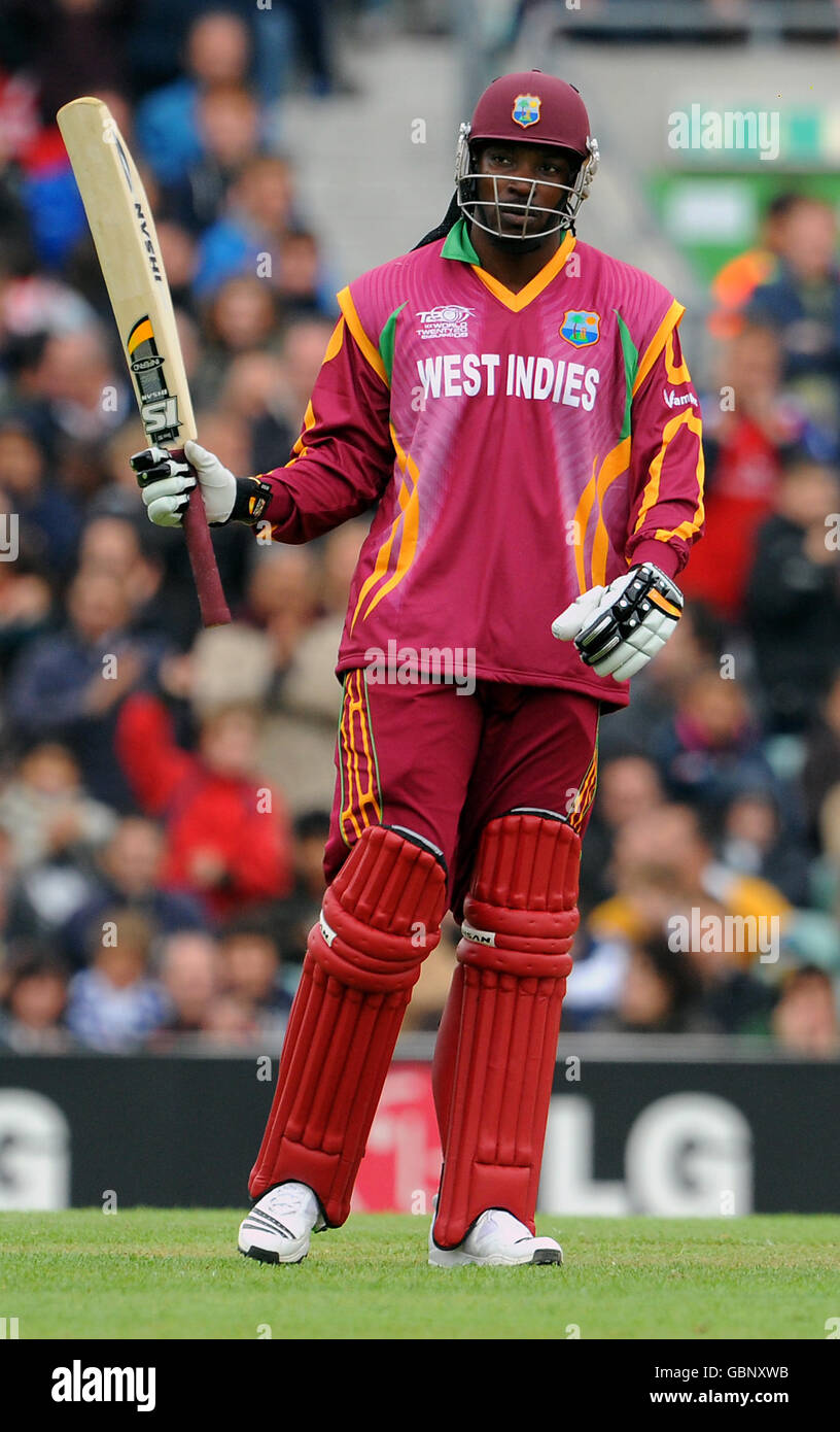 West Indies' Chris Gayle raises his bat to celebrate reaching his half ...