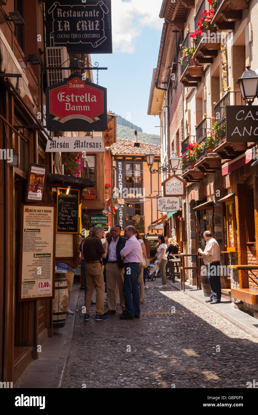 Street scene of people talking and sightseeing in a old back street in ...