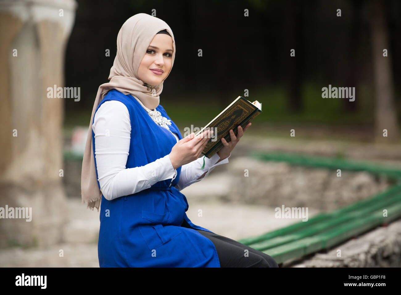 Humble Muslim Woman Is Reading The Koran Outdoors Stock Photo - Alamy