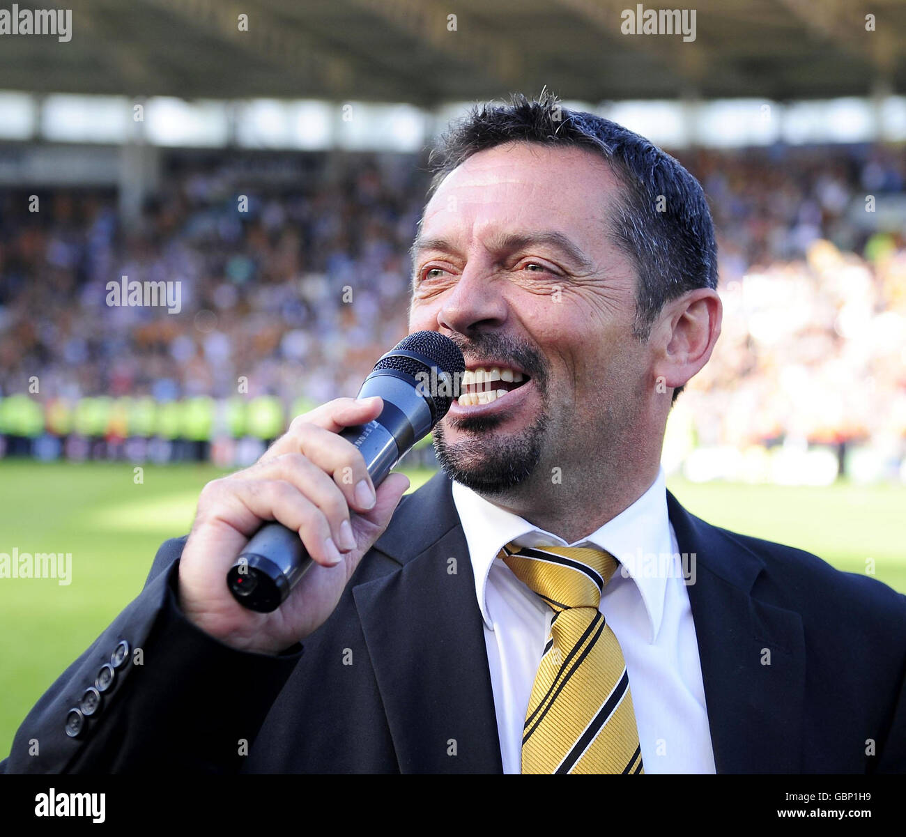 Hull City manager Phil Brown sings to the fans at the final whistle ...