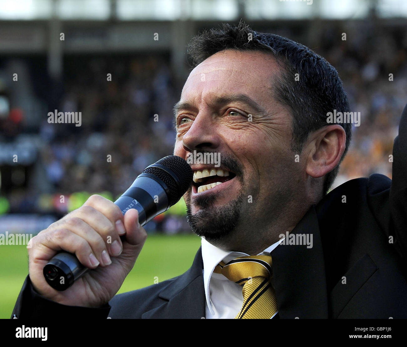 Hull City manager Phil Brown sings to the fans at the final whistle ...