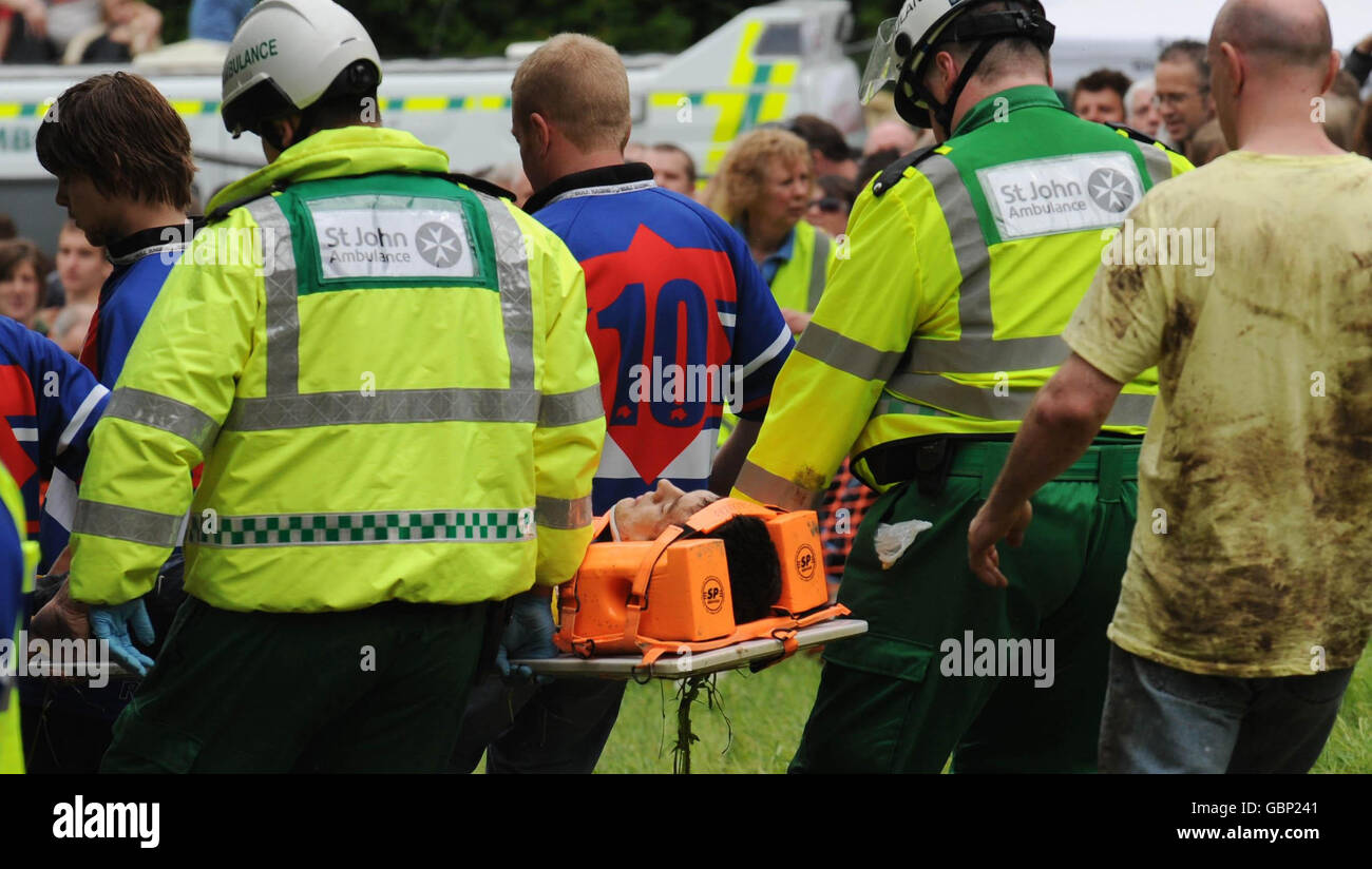 A casualty is carried away on a stretcher after competing in a cheese ...