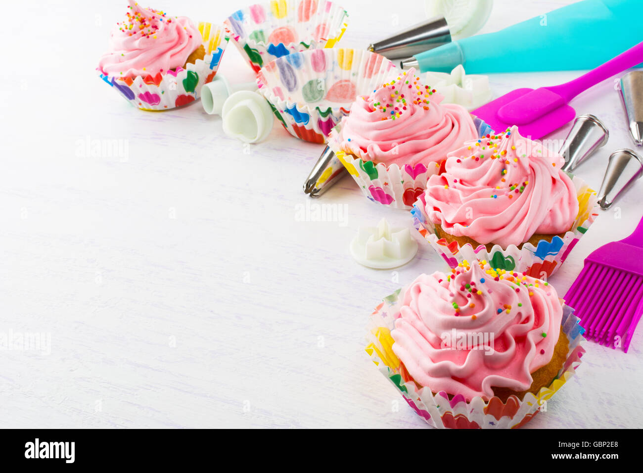 Decorated pink birthday cupcakes and cookware. Birthday homemade ...