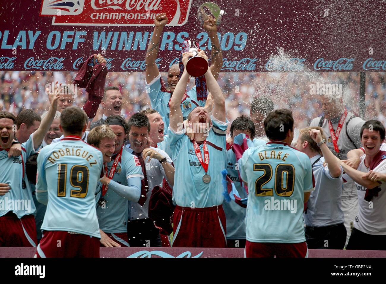 Burnley's Steven Caldwell (centre) celebrates with the trophy and his ...