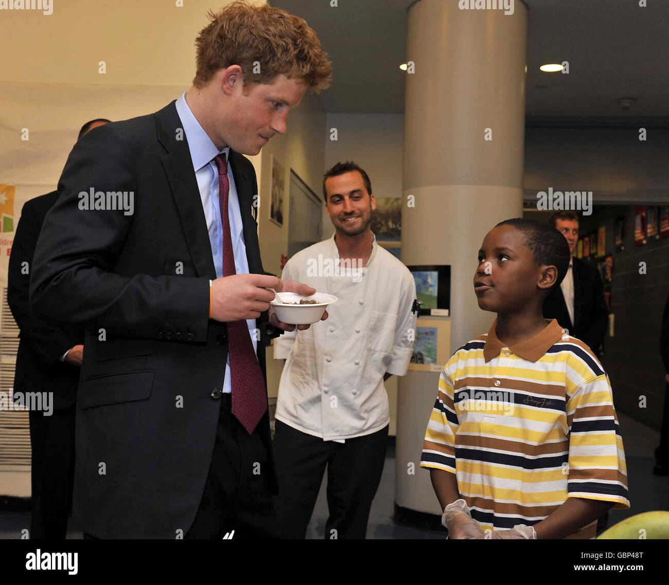 Prince Harry talks to Khalil Davis, 9, during a visit to the Harlem ...