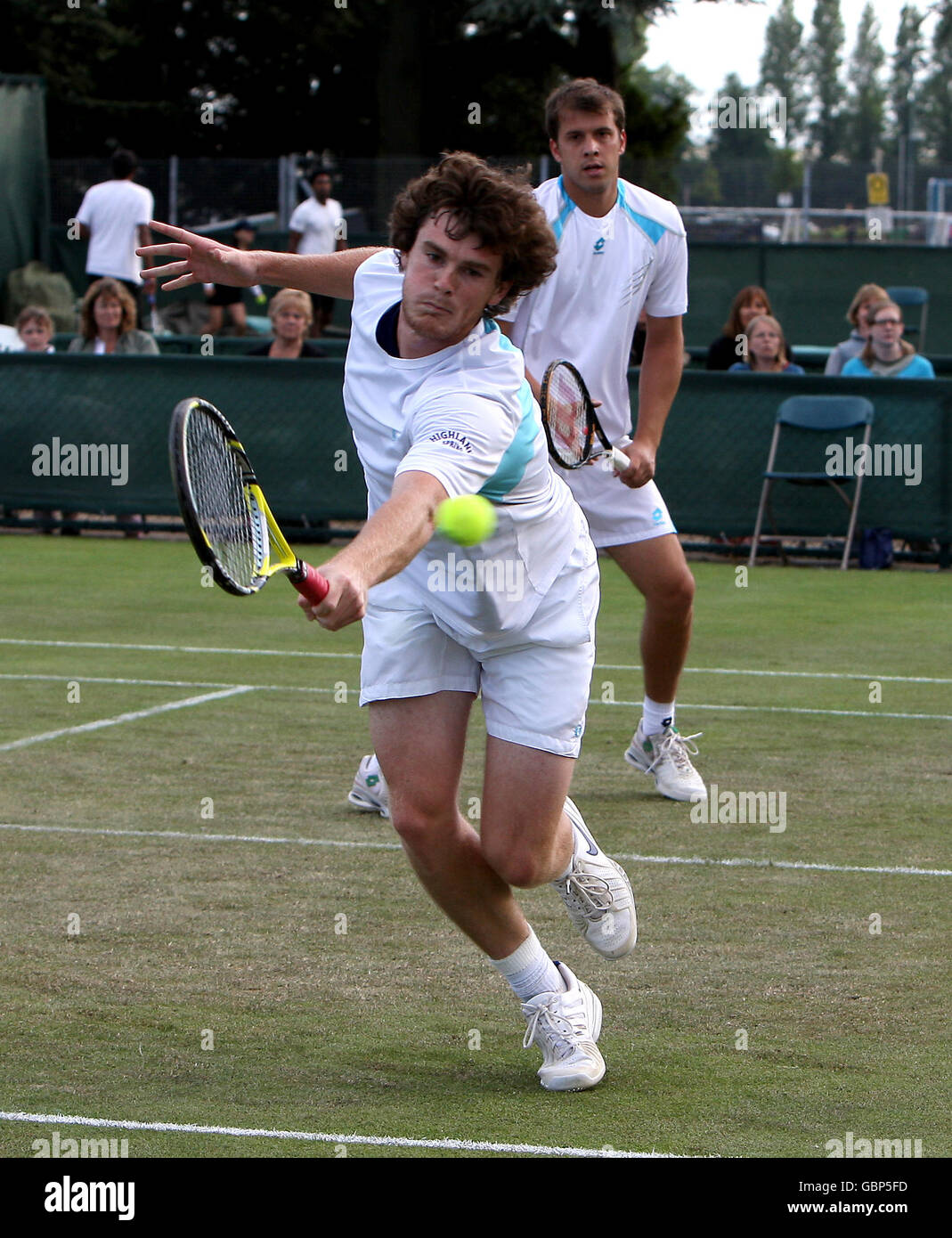 Great Britain's Jamie Murray returns the ball watched by his double's ...