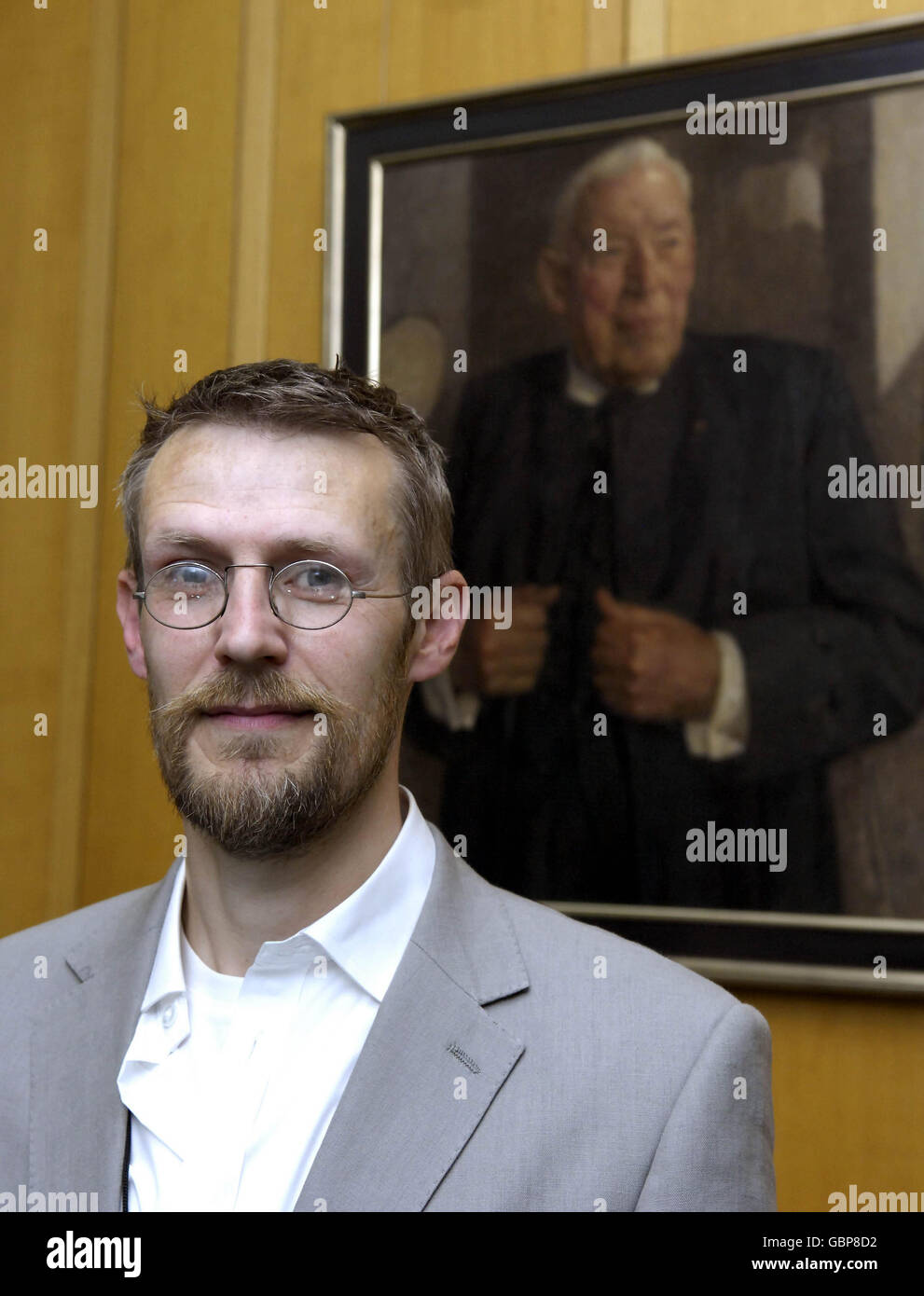 Artist Mark Shields stands in front of his portrait of Dr. Ian Paisley ...