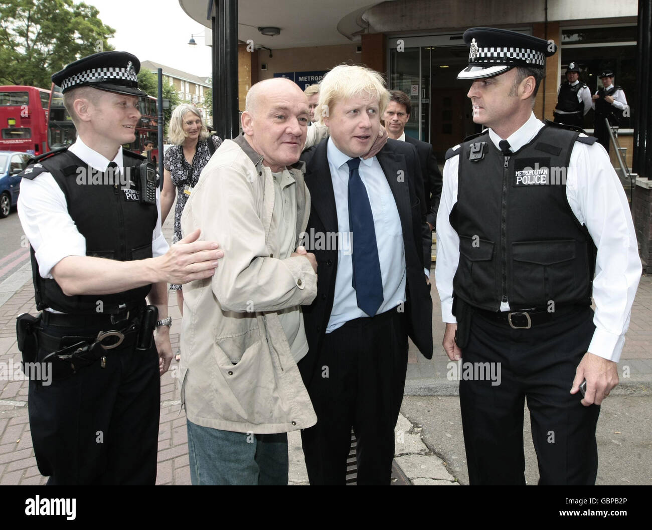 A member of the public greets London Mayor Boris Johnson as he visits ...