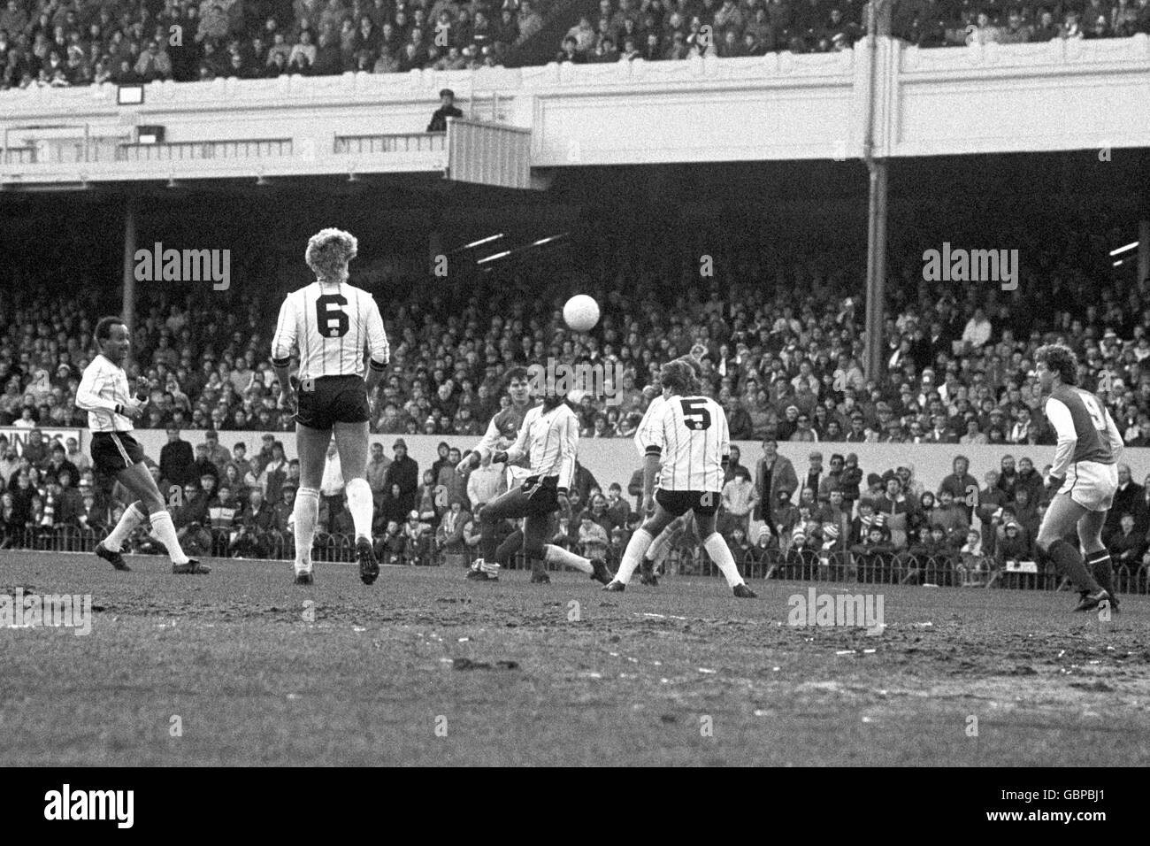 Arsenal's Charlie Nicholas crosses the ball despite the attentions of ...