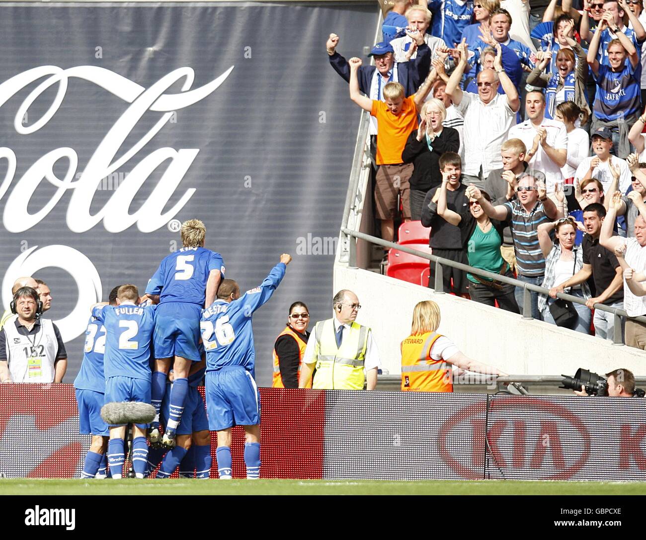 Gillingham players and fans celebrate after Simeon Jackson scored the ...