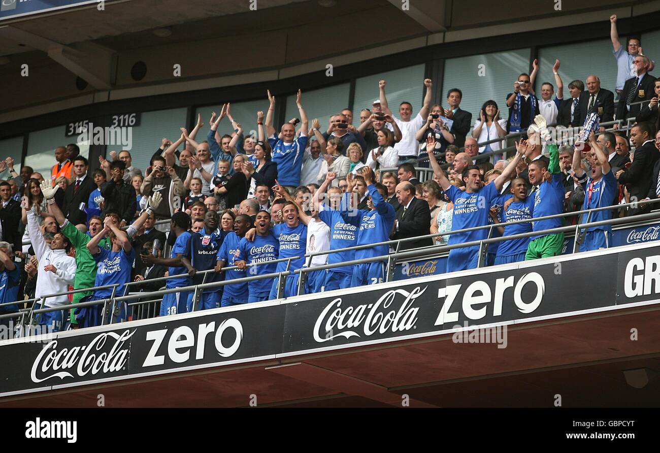 Gillingham captain Barry Fuller (far right) lifts the Coca-Cola ...