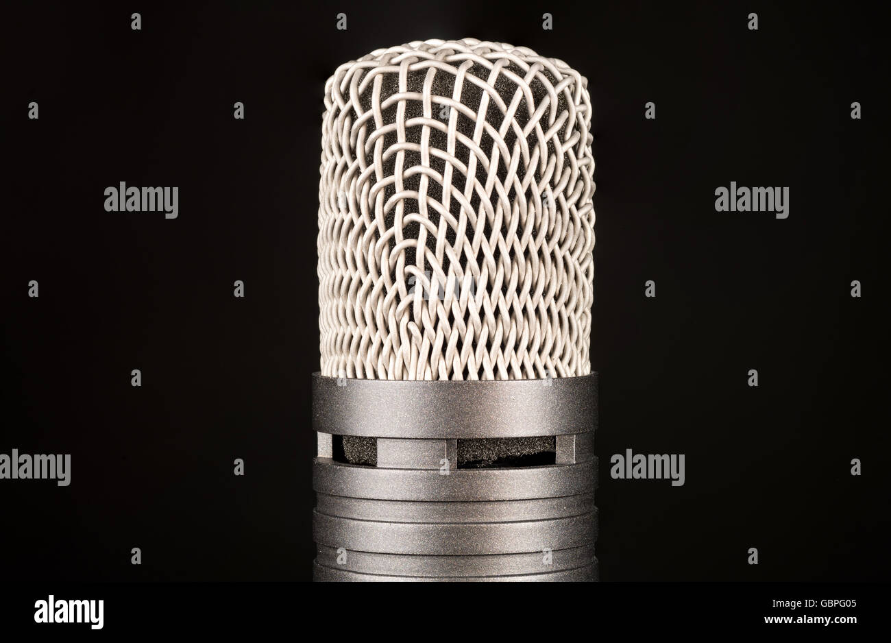 Modern microphone isolated on black Stock Photo - Alamy