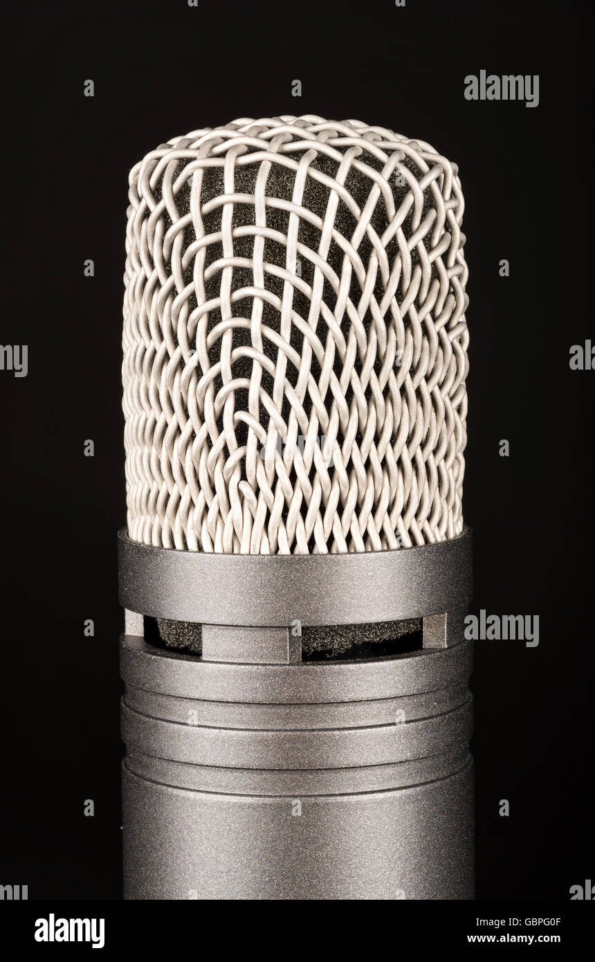 Modern microphone isolated on black Stock Photo - Alamy