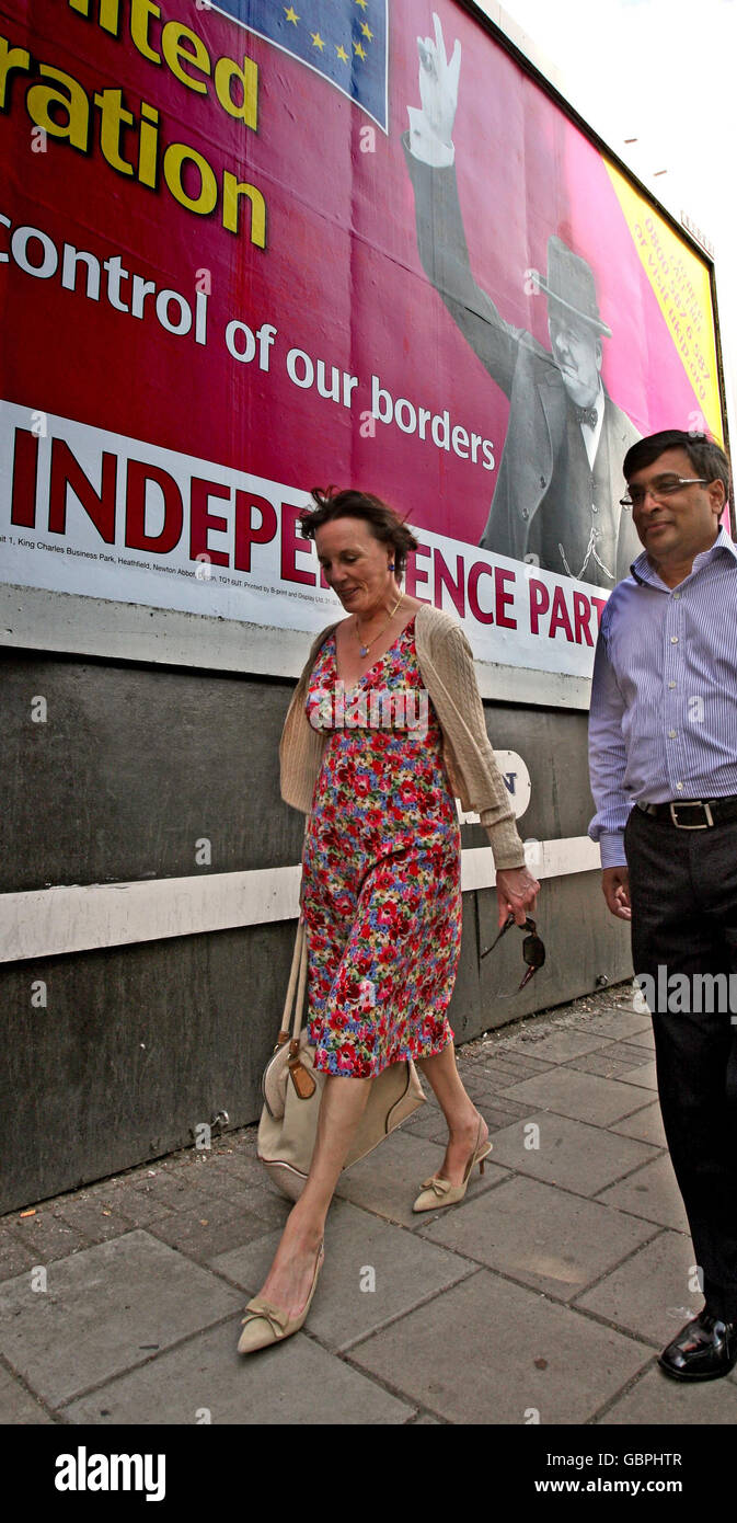 Esther Rantzen walks past a billboard and a picture of Winston ...