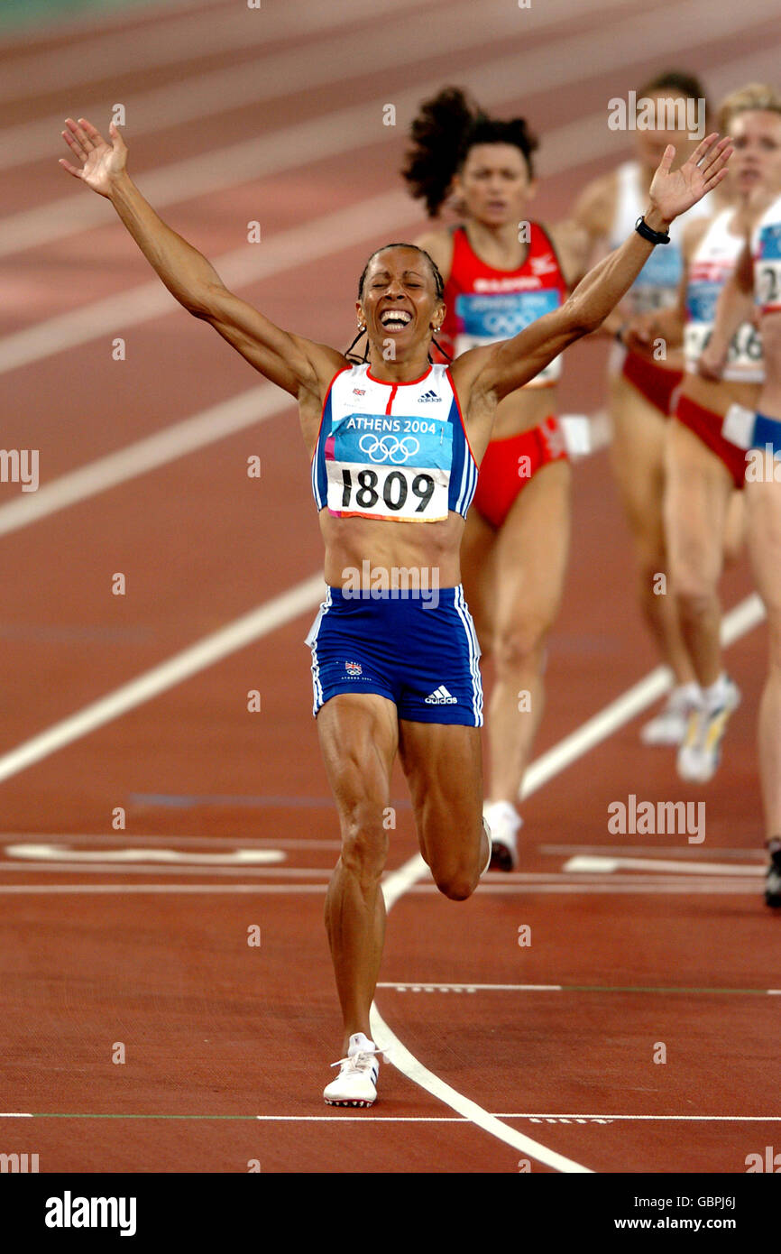 Great Britain's Kelly Holmes celebrates as she crosses the line to win ...