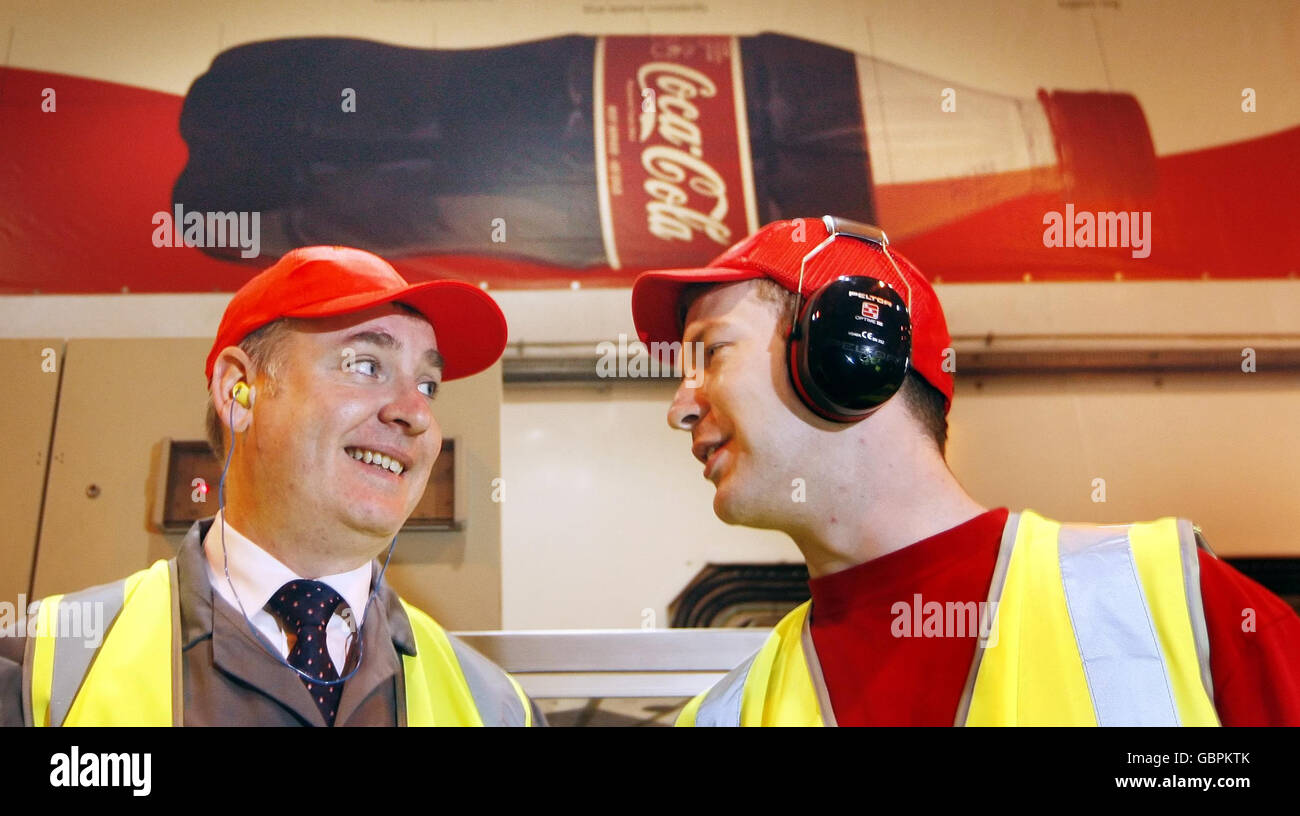 Environment Secretary Richard Lochhead (left) talks to a Coca-Cola ...