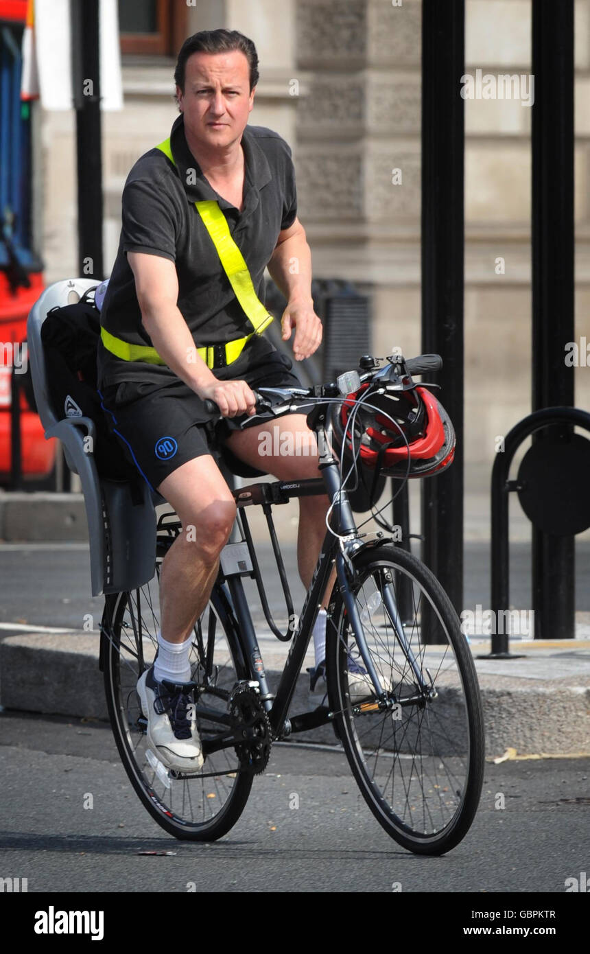 David Cameron arrives at the House of Commons on his bike Stock Photo ...
