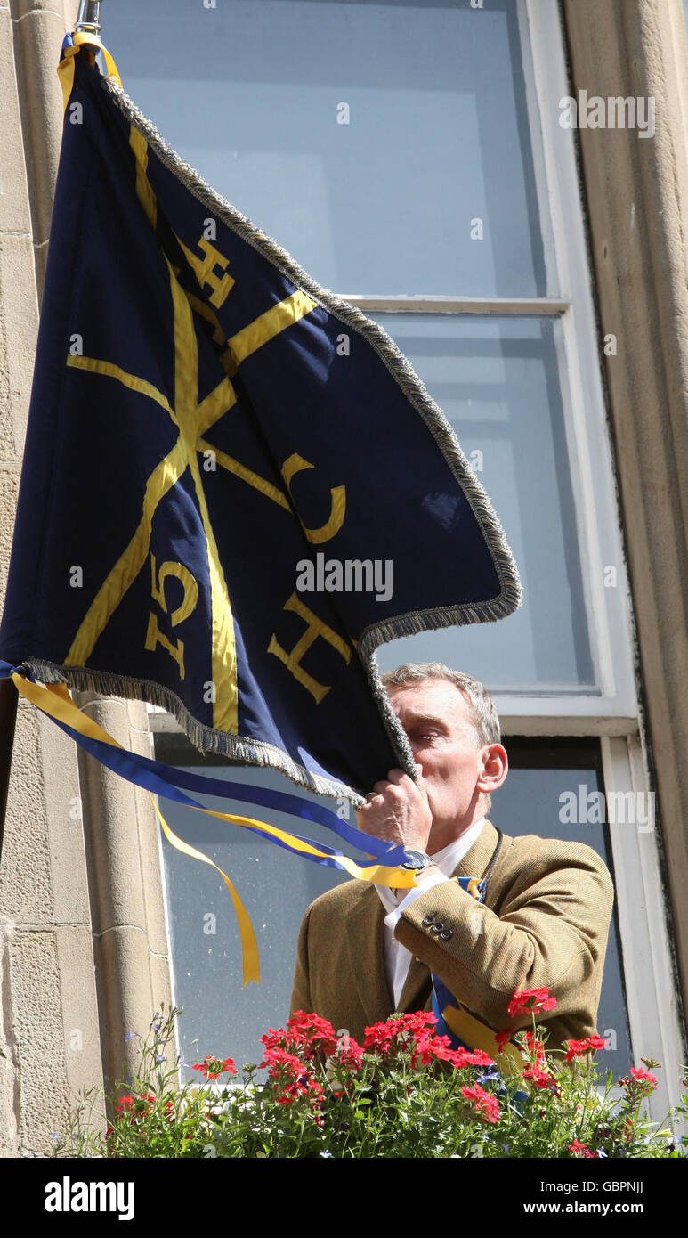 Hawick Common Riding Acting Father Malcolm Grant kisses the 1514 Flag ...