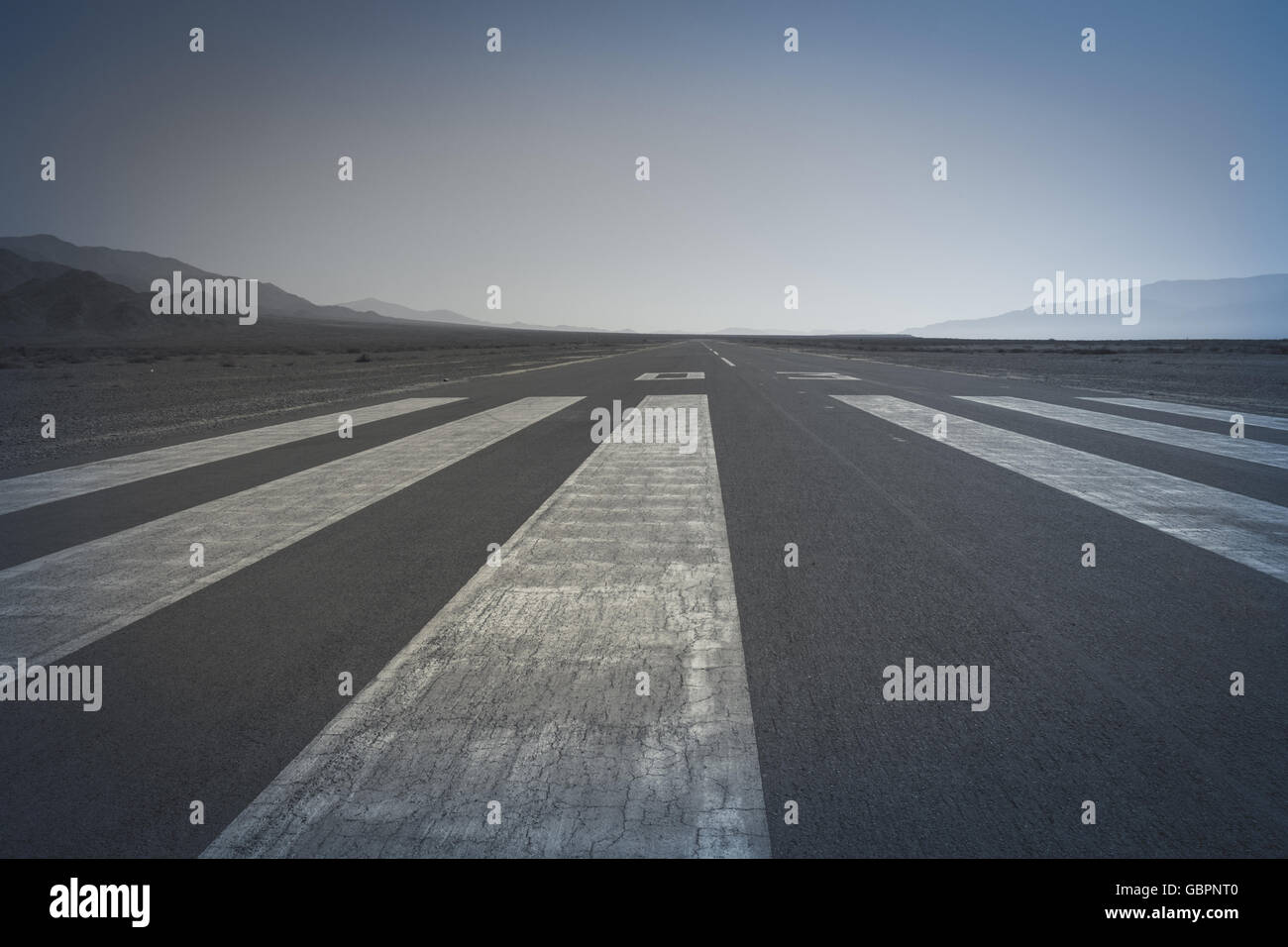 Long paved runway shot from its threshold markings Stock Photo - Alamy