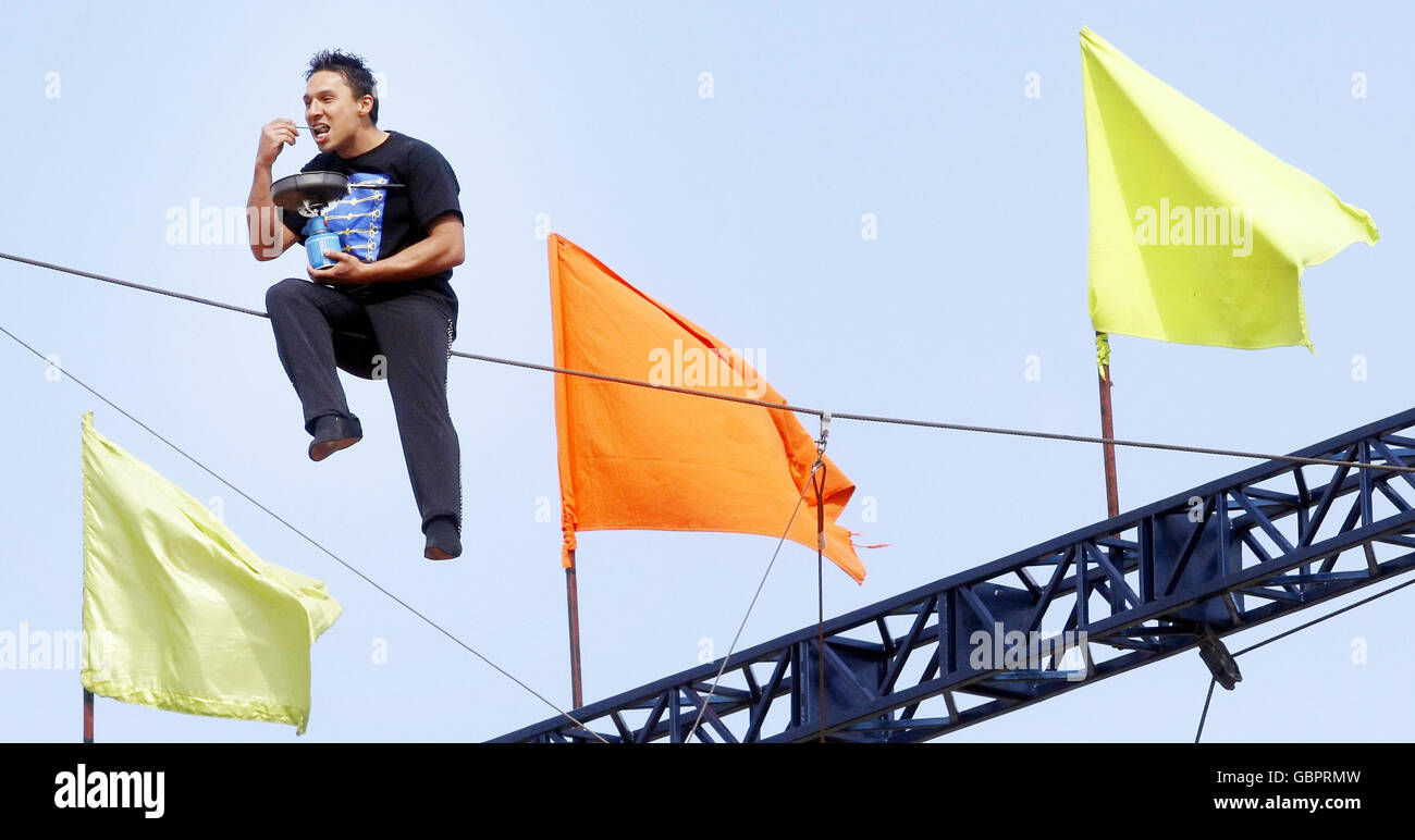 High wire walker Chico Marinhos cooks an omelette whilst walking an ...