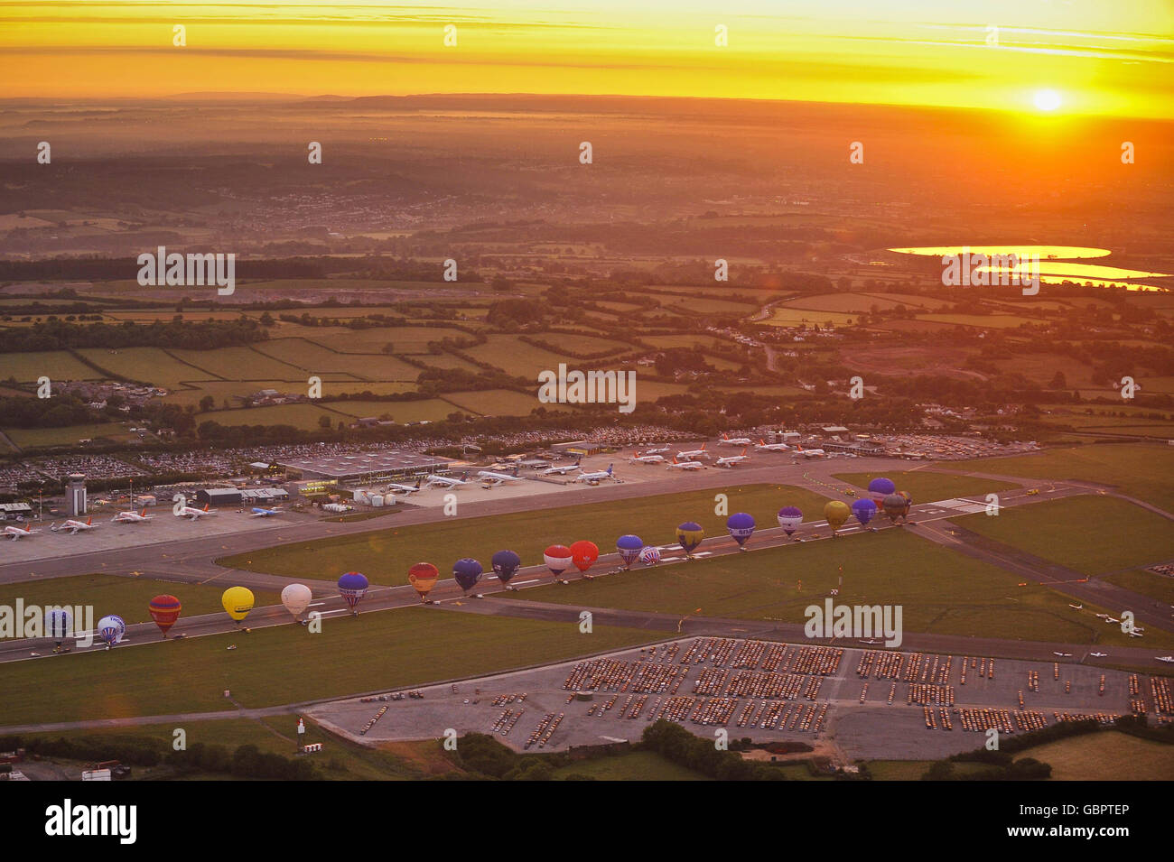 Hot air balloons line up on the main runway at Bristol International ...