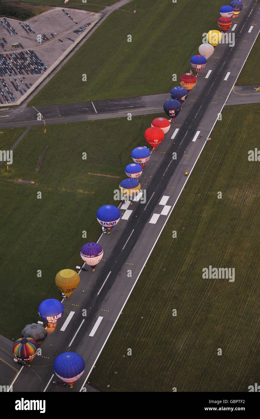Hot air balloons line up on the main runway at Bristol International ...
