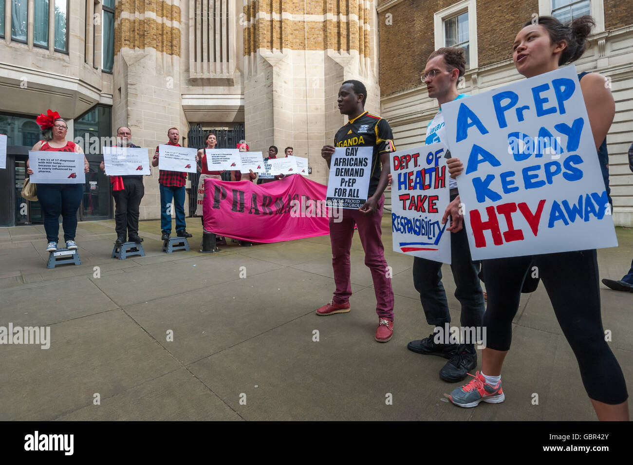 London, UK. 7th July 2016. A line of 17 protesters stand with posters ...