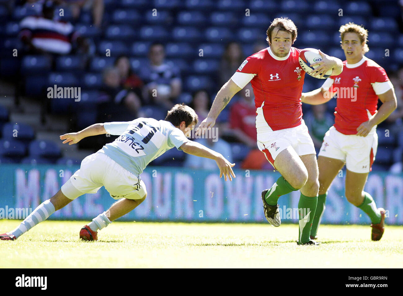 Wales' Rhys Shellard (centre) rounds Argentina's Martin Miguel Nunez ...
