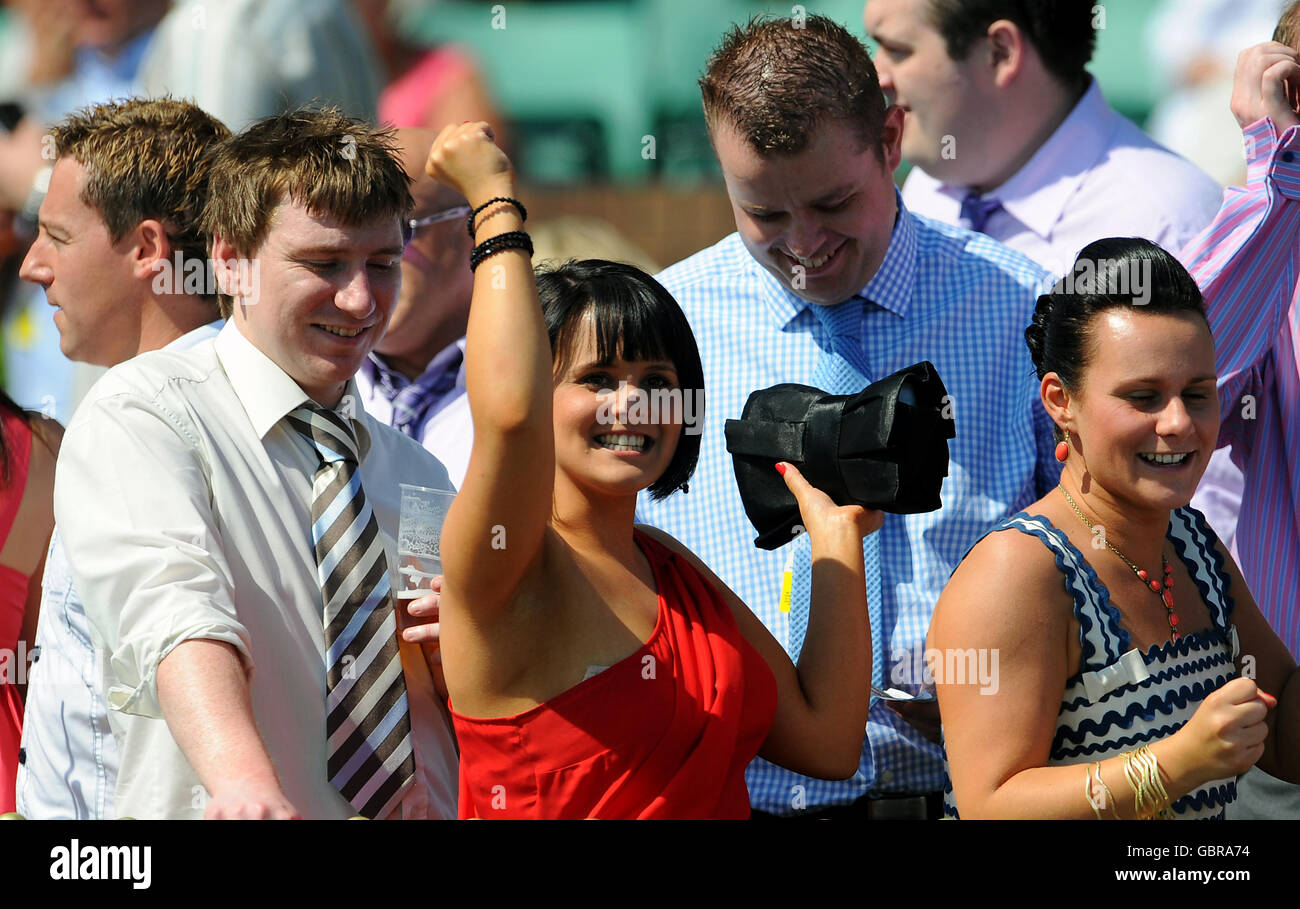 Racegoers celebrate as Main Aim ridden by Richard Moore wins the ...