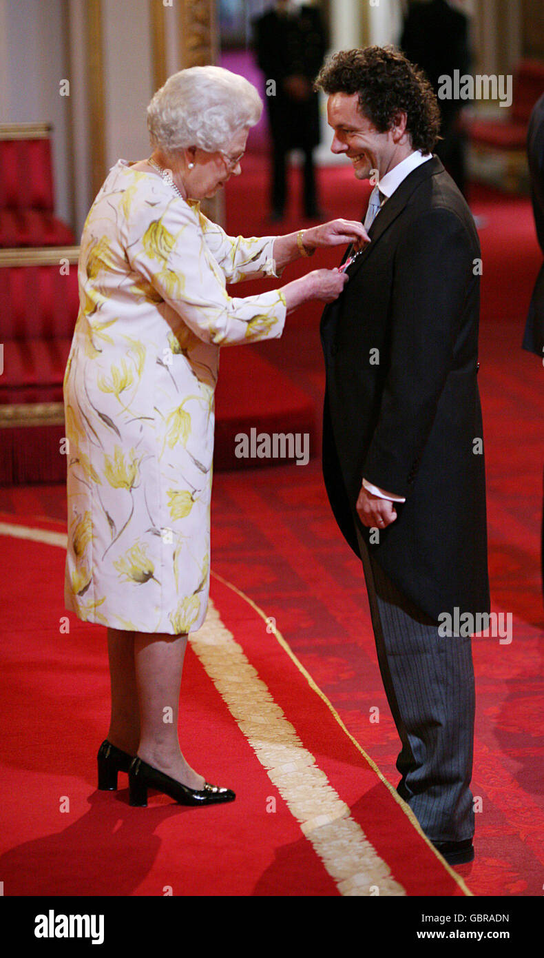 Actor Michael Sheen receives an OBE from Queen Elizabeth II during ...
