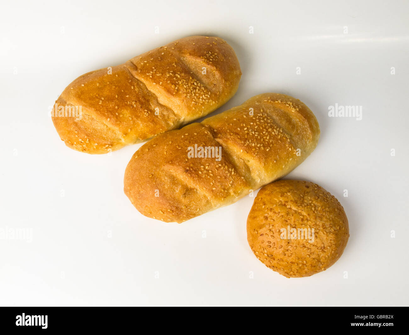 whole wheat two breads and bun on white background Stock Photo - Alamy