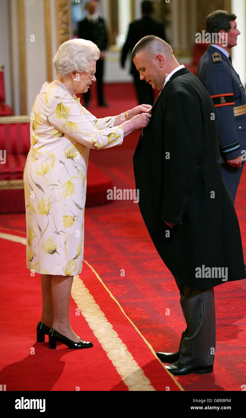 Tube driver David Matthews receives an MBE from Britain's Queen ...
