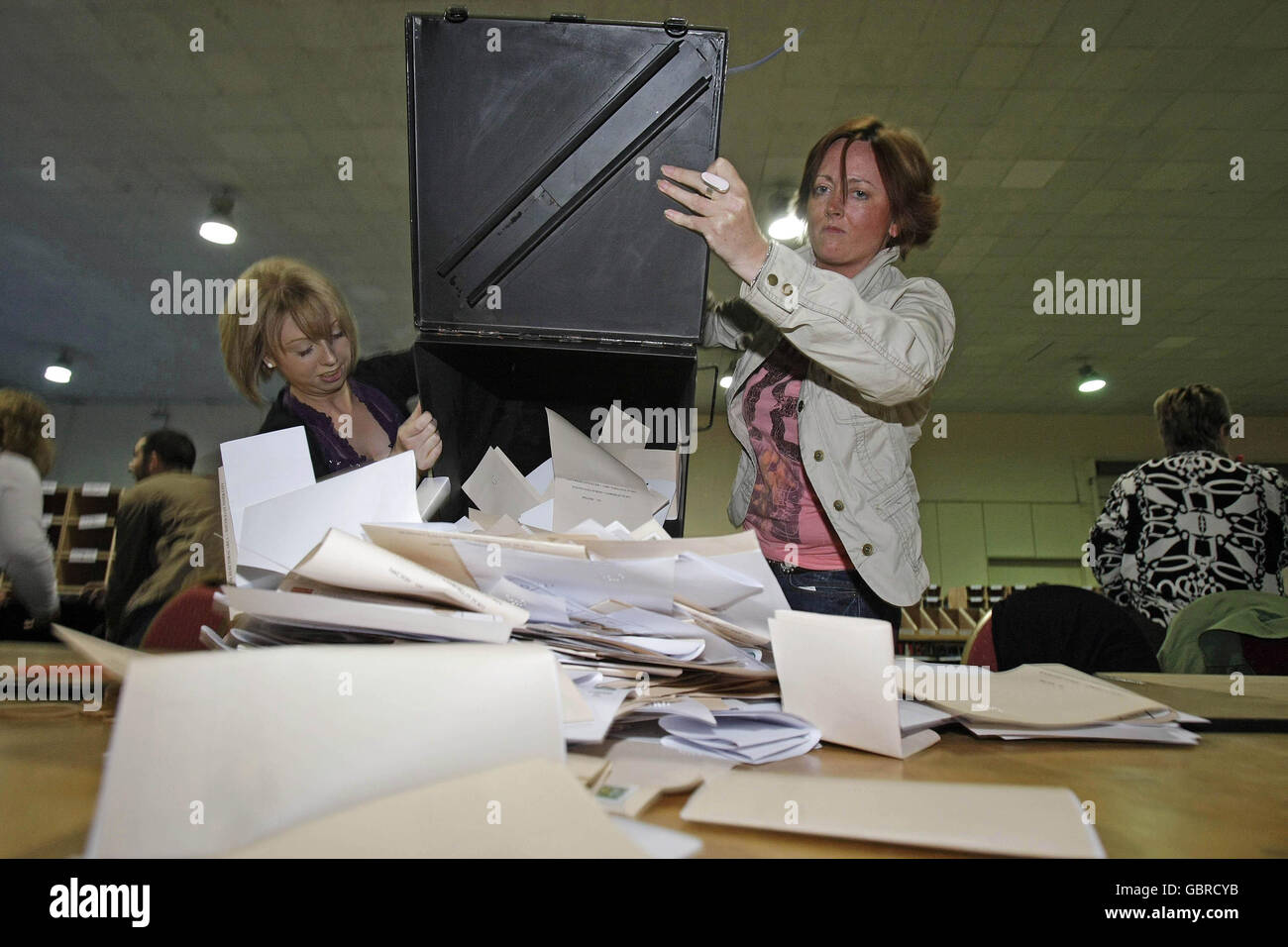 Ballot boxes are opened as the counting of votes begins in the Dublin ...