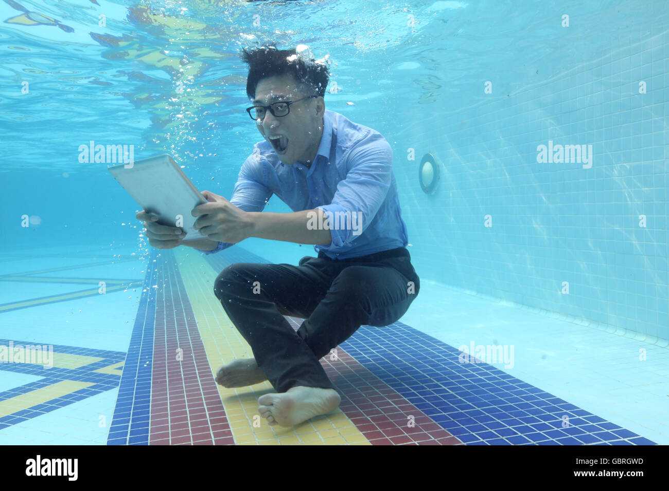 Business men use tablet PCs under water Stock Photo - Alamy