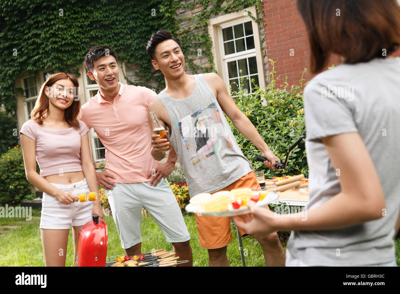 Young people in the yard barbecue Stock Photo - Alamy