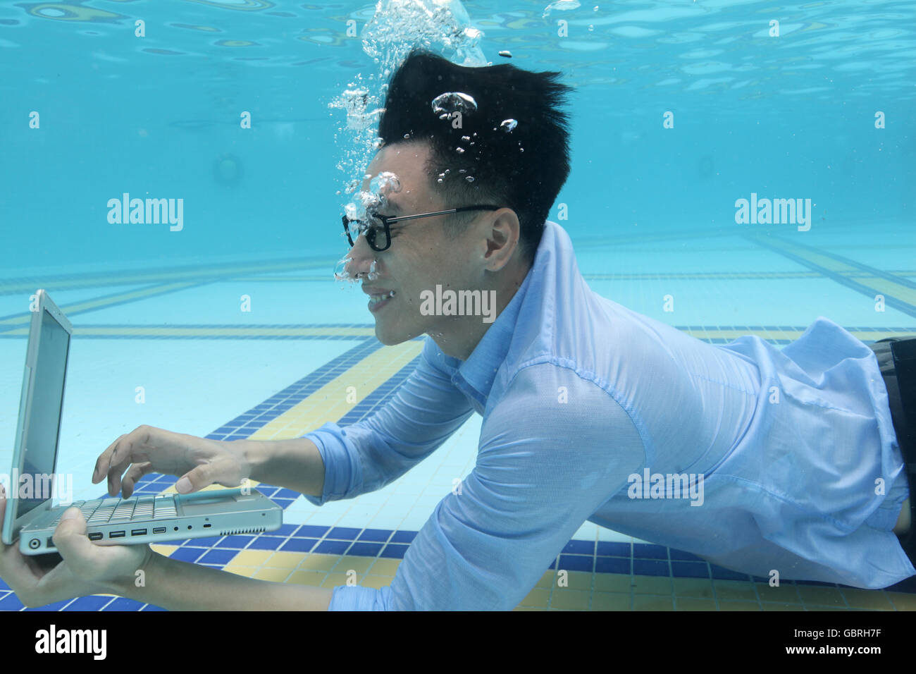 Business men use computers under water Stock Photo - Alamy