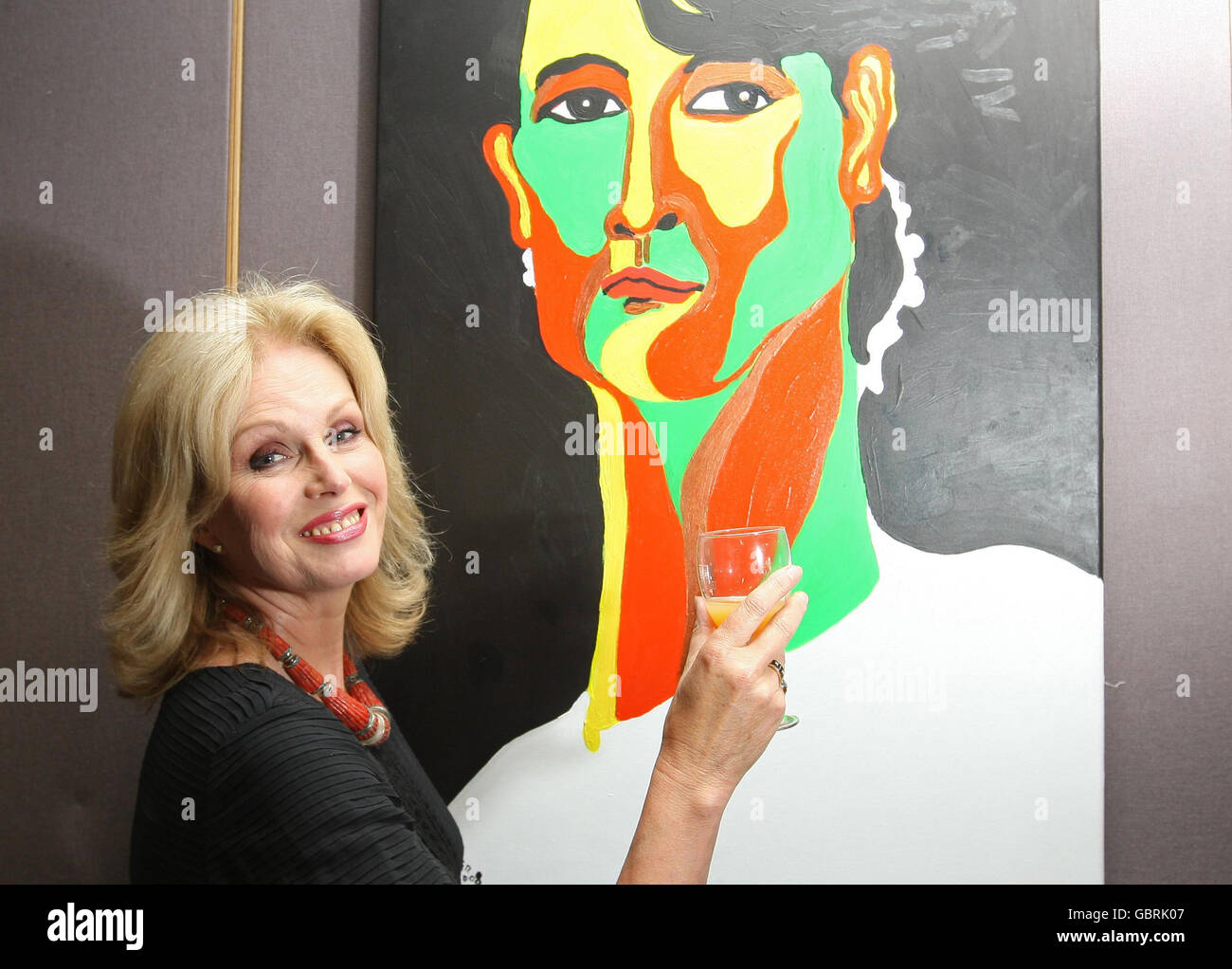 Joanna Lumley stands in front of a portrait of Burmese opposition ...