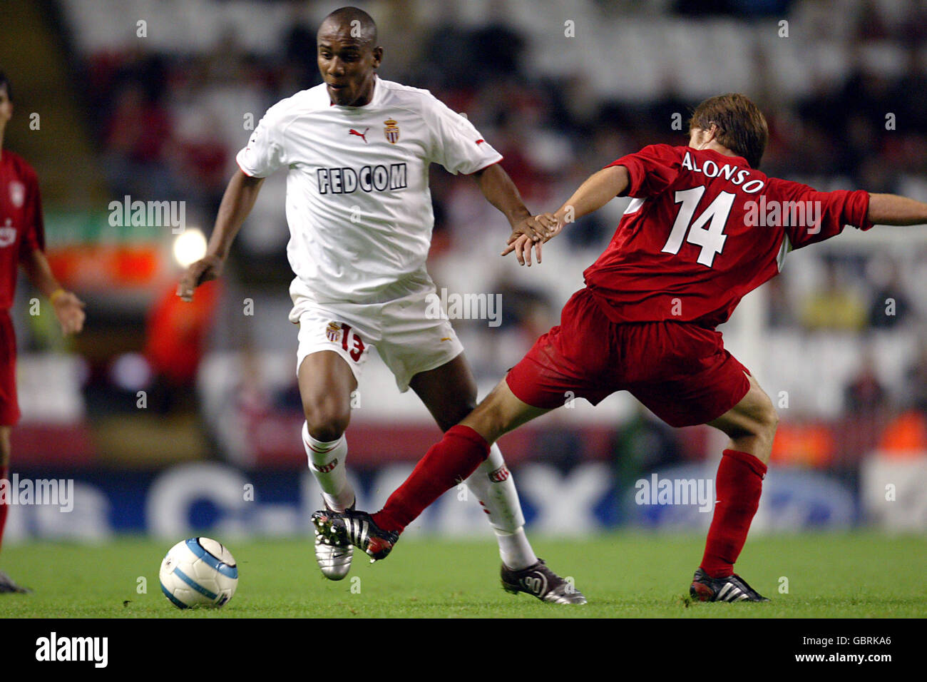 Liverpools xabi alonso and monacos douglas maicon hi-res stock ...