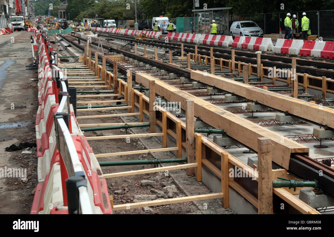 Tram workers cement new tram line Stock Photo - Alamy